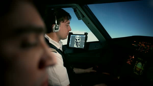 Pilot and co-pilot inside aircraft cockpit flying plane - Stock Video ...