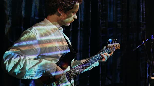 Young bass player playing guitar in a nightclub - Stock Video Footage ...