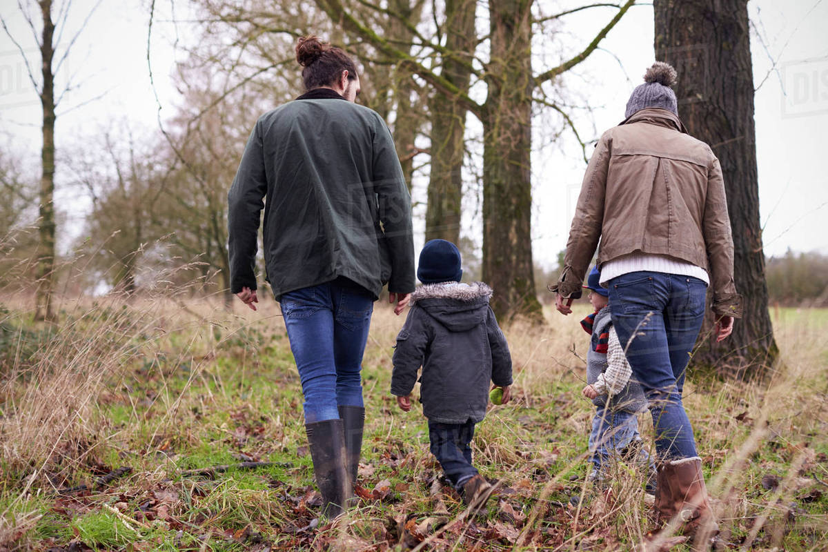 Family on winter walk in countryside together - Stock Photo - Dissolve