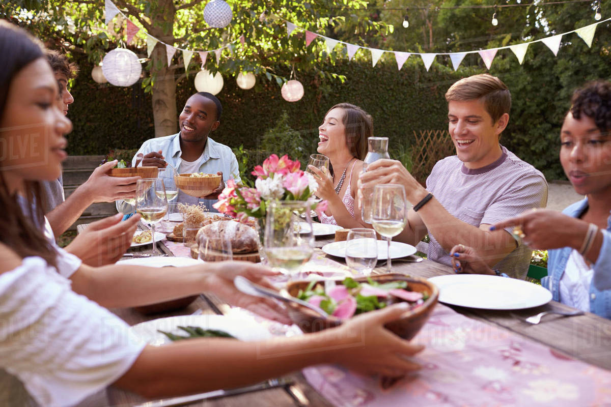 Friends Eating And Drinking Around Table At Outdoor Party - Stock Photo ...