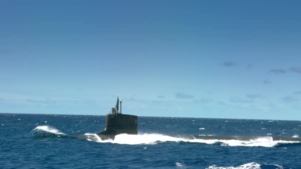 Tracking shot of a military submarine breaching surface - Stock Video ...