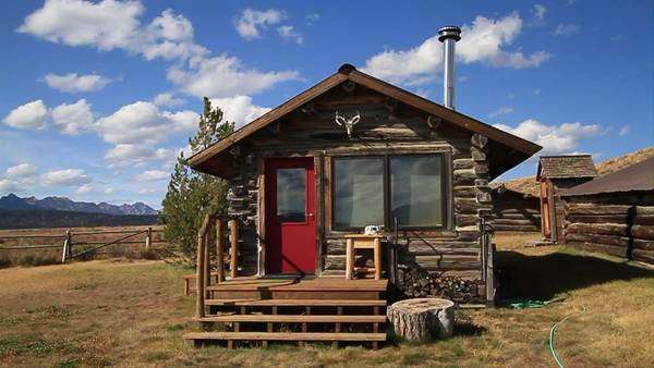 Locked-off shot of wooden house with mountains in the background - HD ...