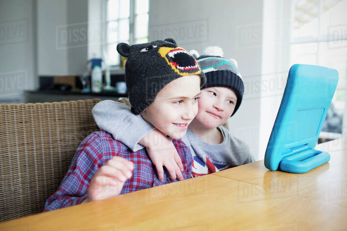 Brothers using computer at home - Royalty-free Stock Photo | Dissolve