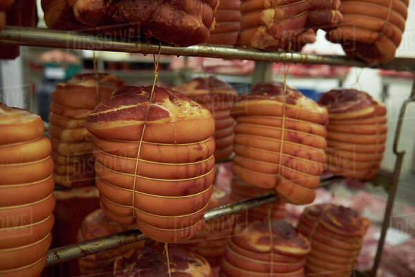 Prepared joints of meat hanging in butchers cold store - Royalty-free ...