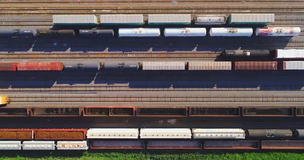 Looking straight down on industrial railroad rail train yard, many ...