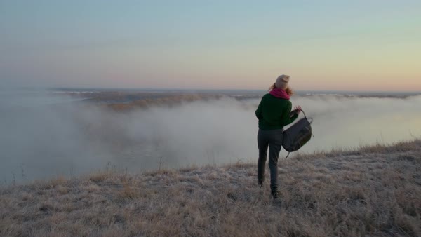 Woman tourist walks into the fog and enjoys nature. - Stock Video ...