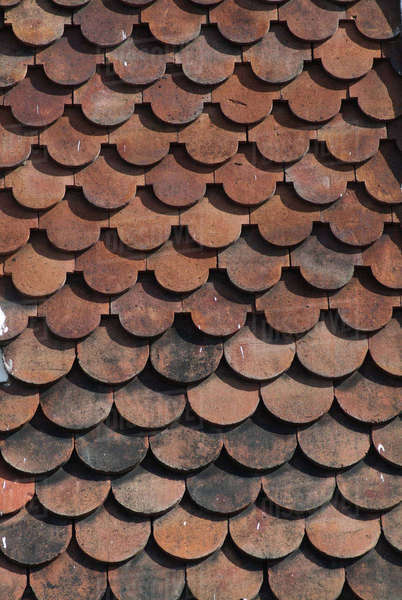 Close up of red shingles roof tiles. - Royalty-free Stock Photo | Dissolve