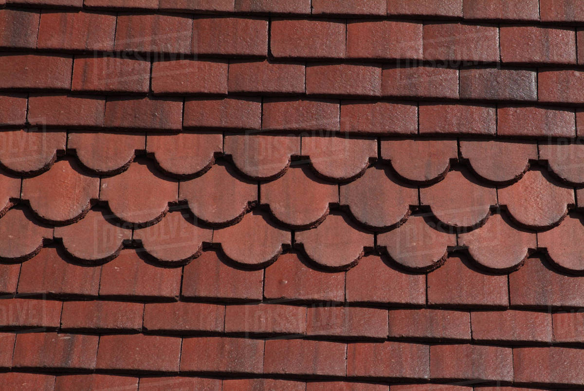 Close up of straight and scalloped red clay roof tiles. - Royalty-free ...