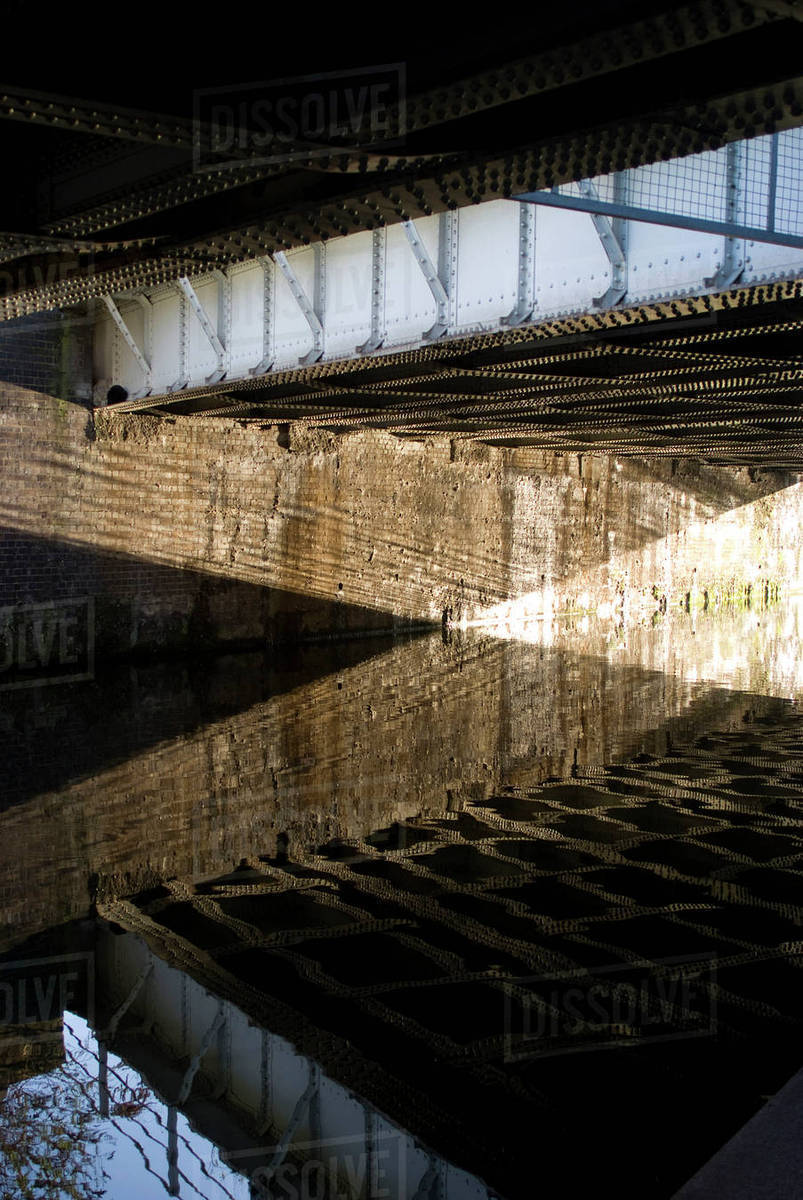 Reflections under a railway bridge - Stock Photo - Dissolve