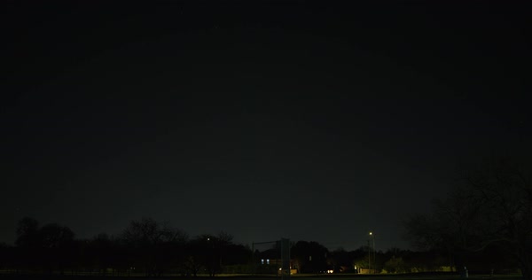 Shot of dark night sky over city, suburb, plane in distance, 4K ...