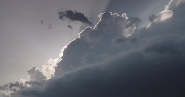 Sunbeam shines over top of growing storm clouds, time-lapse, sky only ...
