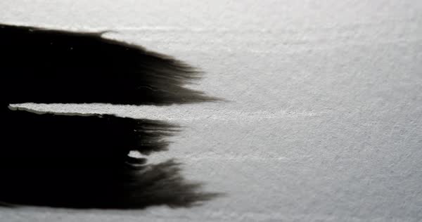 Black ink bleeding on white paper in amazing detail - Stock Video ...