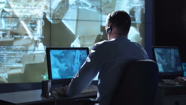 A man in headphones in the control center of space flights controls the ...