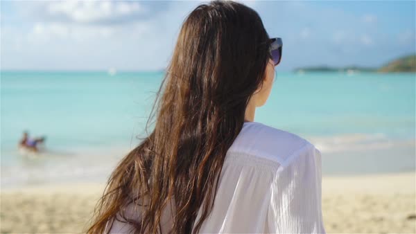 Back view of young woman on tropical white beach - Stock Video Footage ...