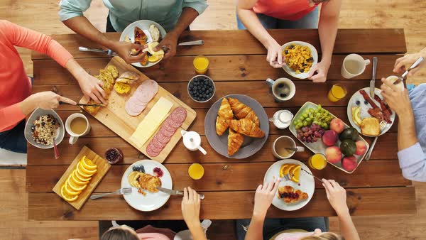 Group of people eating at table with food - 4K Royalty-free Stock Video ...