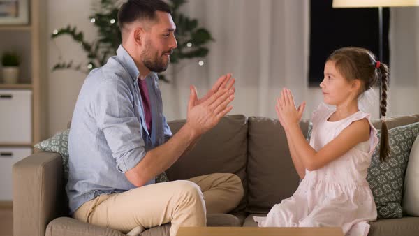 Father and daughter playing clapping game at home - Stock Video Footage ...