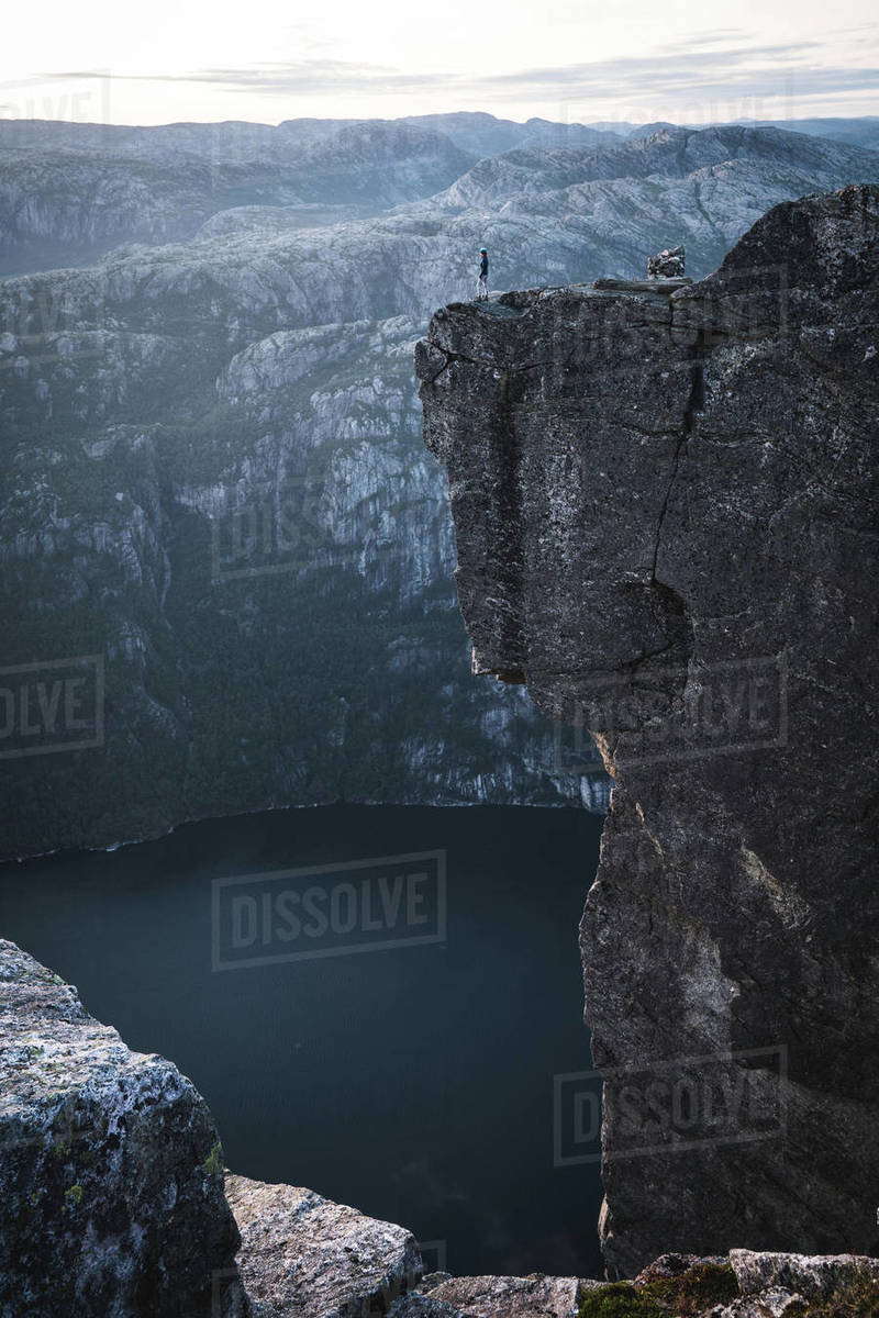 Woman looking at view while standing on top of cliff - Royalty-free ...