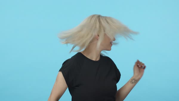 Blond woman having fun, whipping hair and shaking head - Stock Video ...