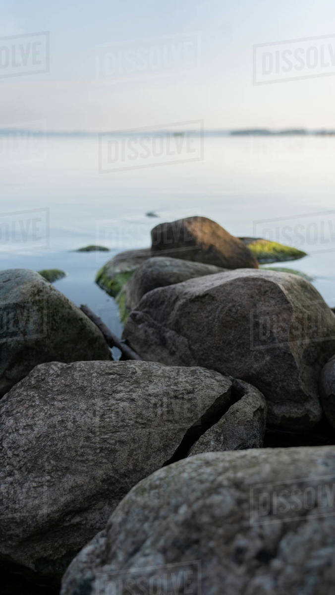A cracked cobblestone on the wild rocky shore of the lake. High quality ...