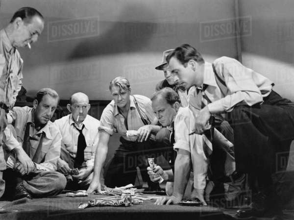 Group of men gambling - Stock Photo - Dissolve