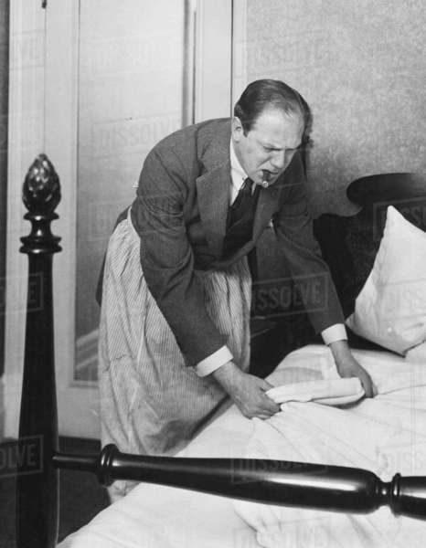 Man making bed - Royalty-free Stock Photo | Dissolve