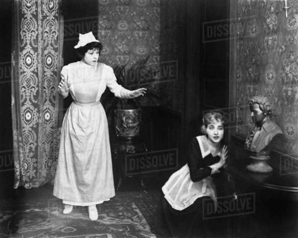 Woman caught eavesdropping at door - Royalty-free Stock Photo | Dissolve