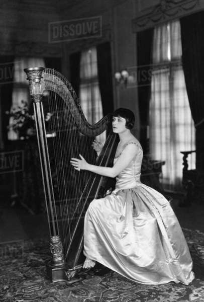 Woman playing harp - Stock Photo - Dissolve