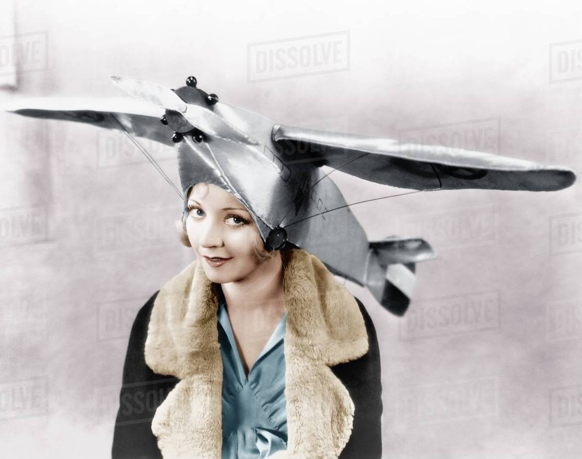 Portrait of a young woman wearing an airplane shaped cap - Royalty-free ...