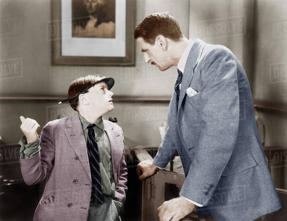 Man talking to a young boy reporter - Royalty-free Stock Photo | Dissolve