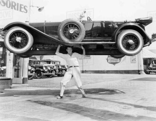 Strong man lifting a car over his head - Royalty-free Stock Photo ...