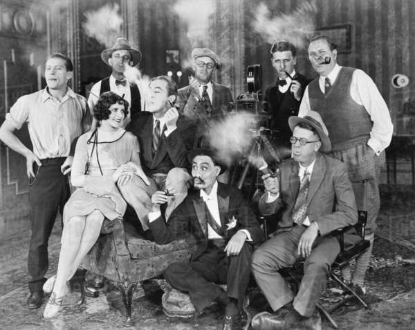 Group of people sitting in a living room smoking - Royalty-free Stock ...