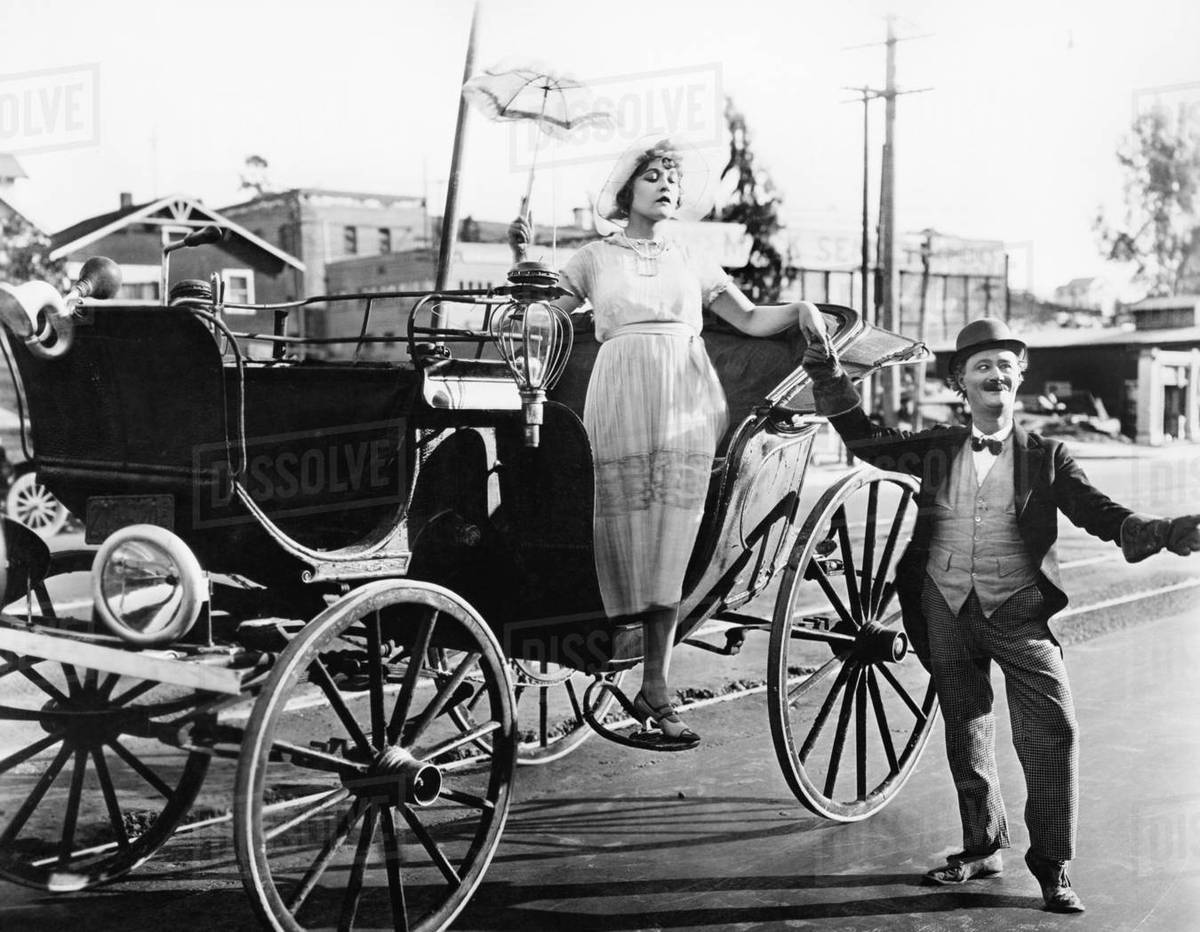 Man helping a woman get out of a wagon - Royalty-free Stock Photo ...