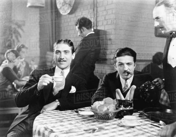 Two men sitting together at a restaurant - Stock Photo - Dissolve