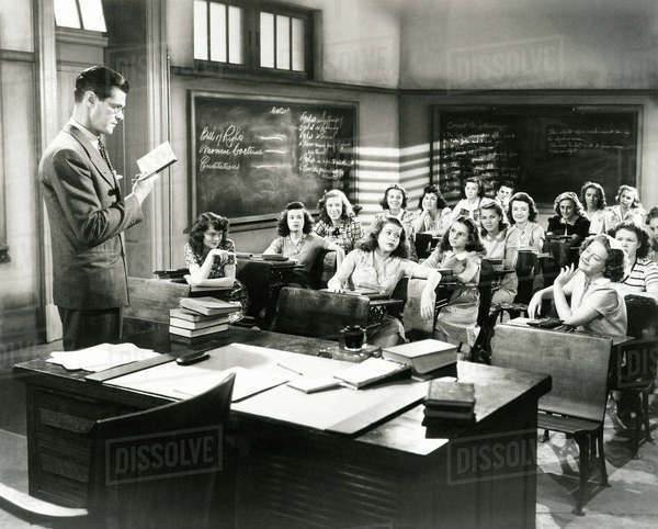 Teacher spanking a girl in a classroom - Stock Photo - Dissolve