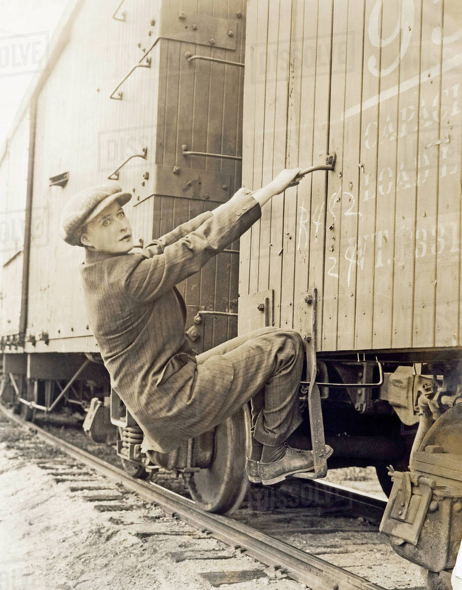 Female hobo climbing freight train - Royalty-free Stock Photo | Dissolve