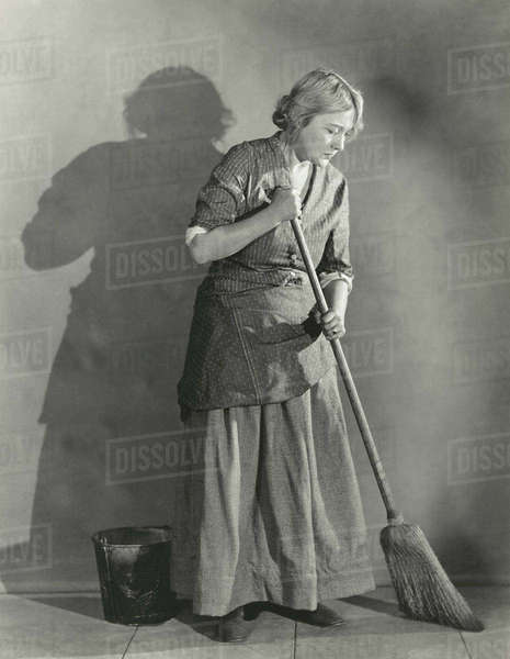 Woman sweeping floor - Stock Photo - Dissolve