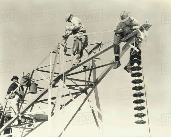 Men working on power lines - Stock Photo - Dissolve