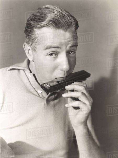 Man playing the harmonica - Royalty-free Stock Photo | Dissolve