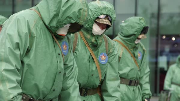 People in bio viral hazard protective suits. Disinfection and ...