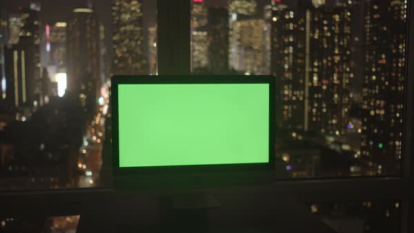 Computer monitor with isolated green screen background standing on work ...
