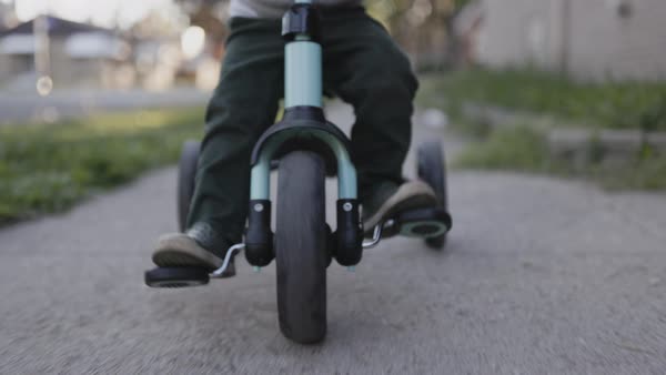 Point-of-view shot of a boy riding tricycle on street - 4K Royalty-free ...