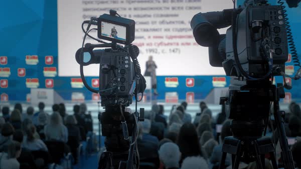 The cameraman makes video for television. Auditorium, seminar and ...