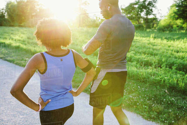 Couple walking on path in park - Stock Photo - Dissolve