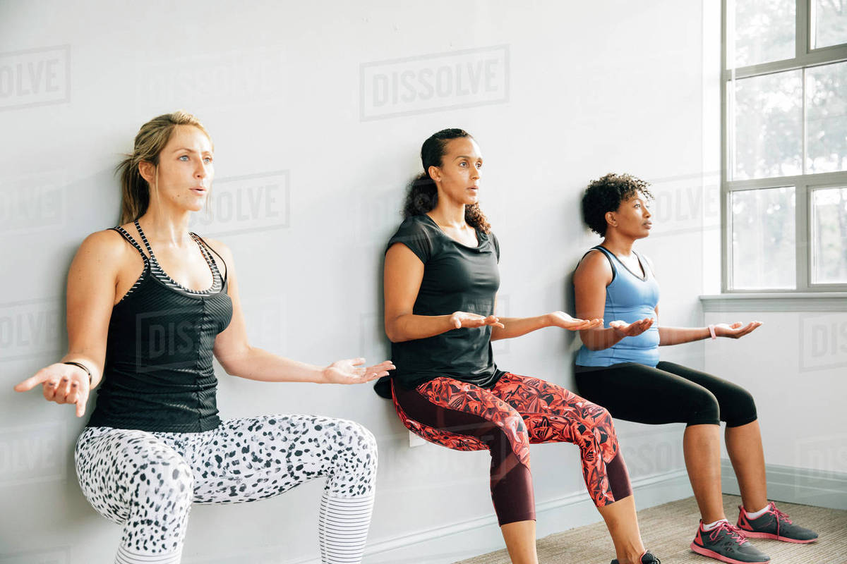 Women leaning on wall in exercise studio - Stock Photo - Dissolve