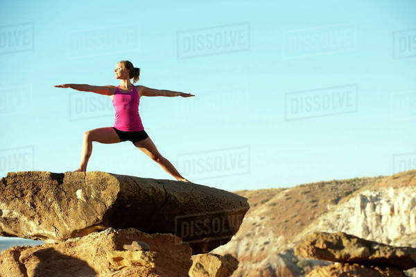 Caucasian woman practicing yoga on top of rock formation - Stock Photo ...