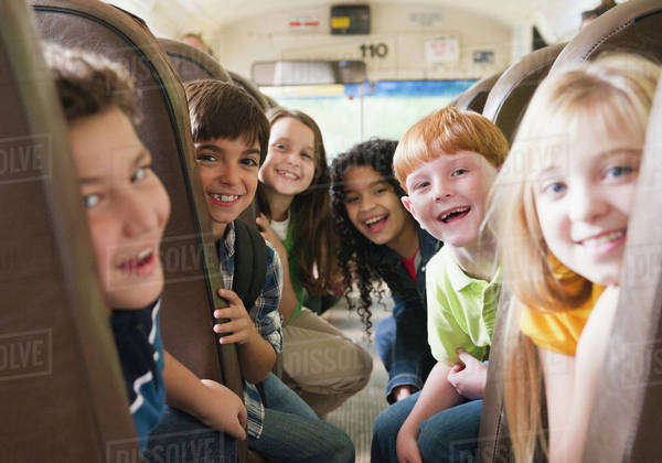 Children riding school bus - Stock Photo - Dissolve
