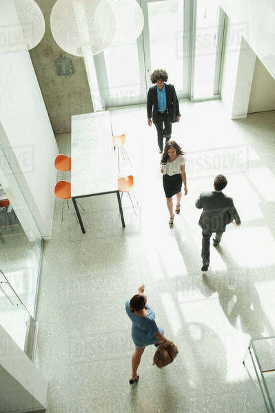 Business people walking in office - Royalty-free Stock Photo | Dissolve