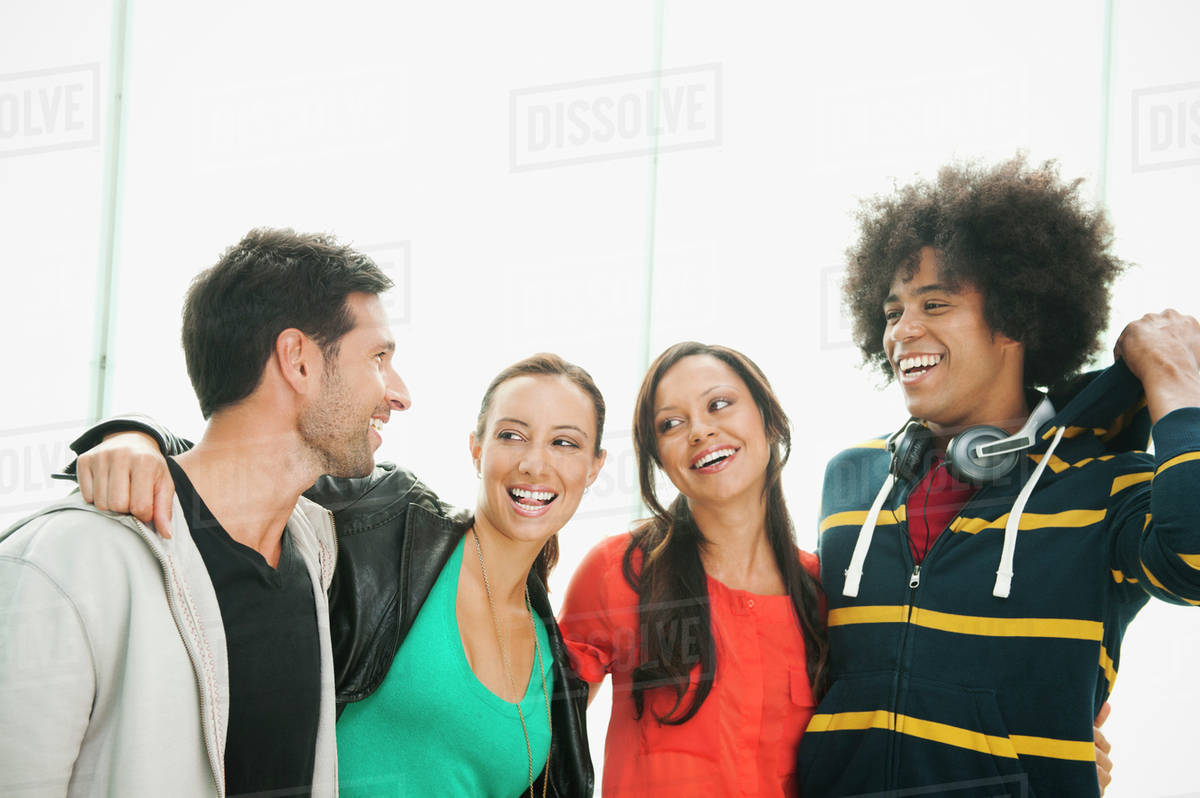 Smiling friends standing together - Royalty-free Stock Photo | Dissolve
