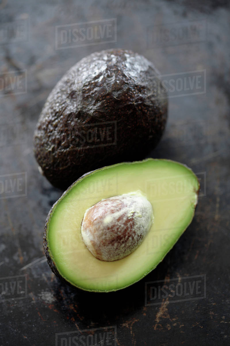 Cut open avocado - Stock Photo - Dissolve