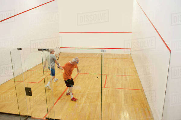 Hispanic men playing racquetball - Stock Photo - Dissolve